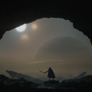 A predator's silhouette stands at a cave entrance